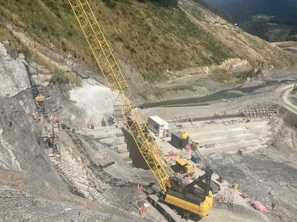 Upstream view of completed Starter Dam and concrete pour in RH plinth ...