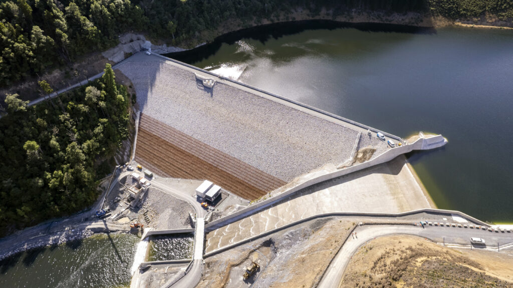 Overview of the dam, water flowing over spillway – Waimea Water